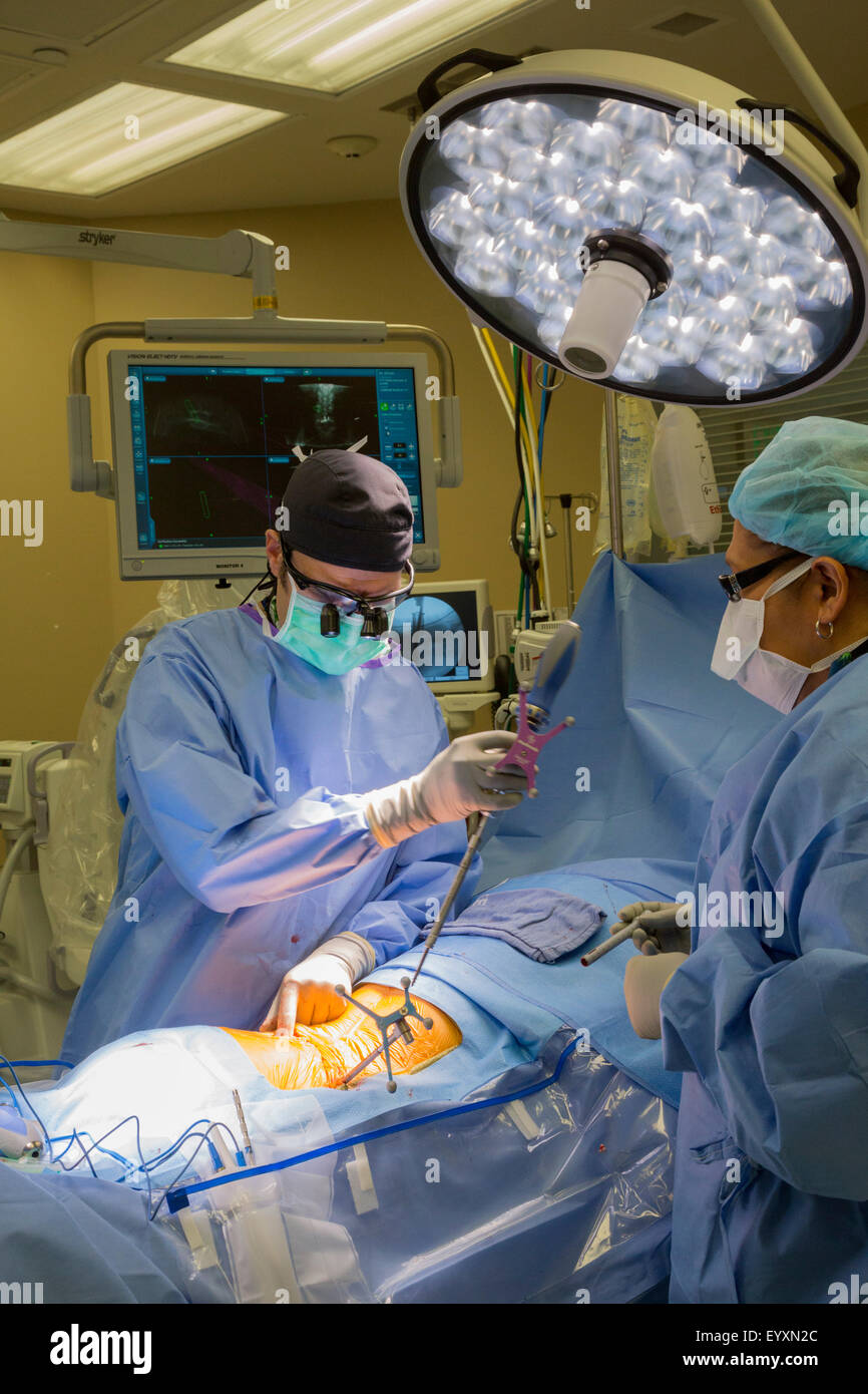 Englewood, Colorado - Dr. Erik Parker (left) performs minimally ...