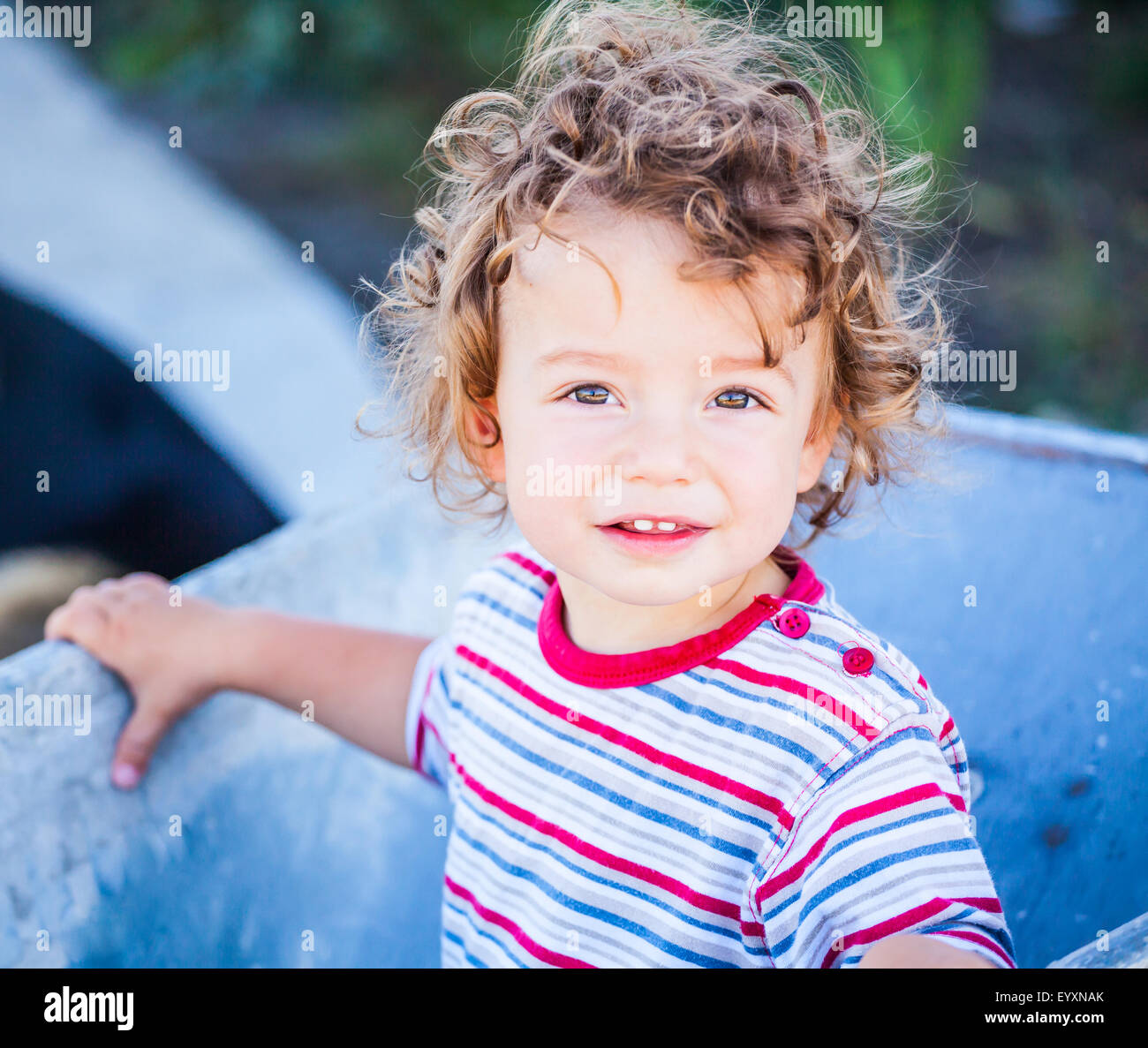 Portrait of 1 year old baby boy playing with a wheel barrow Stock Photo ...