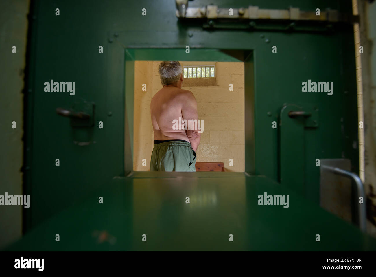 Warders view of prisoner in cell Stock Photo - Alamy