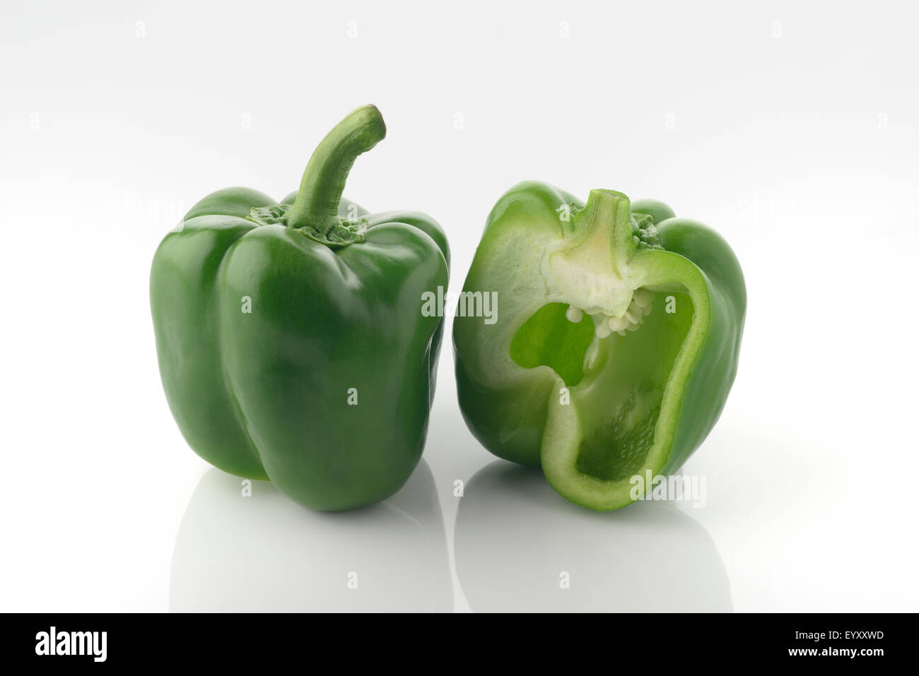 Green Bell Pepper with Cross section on white background Stock Photo ...