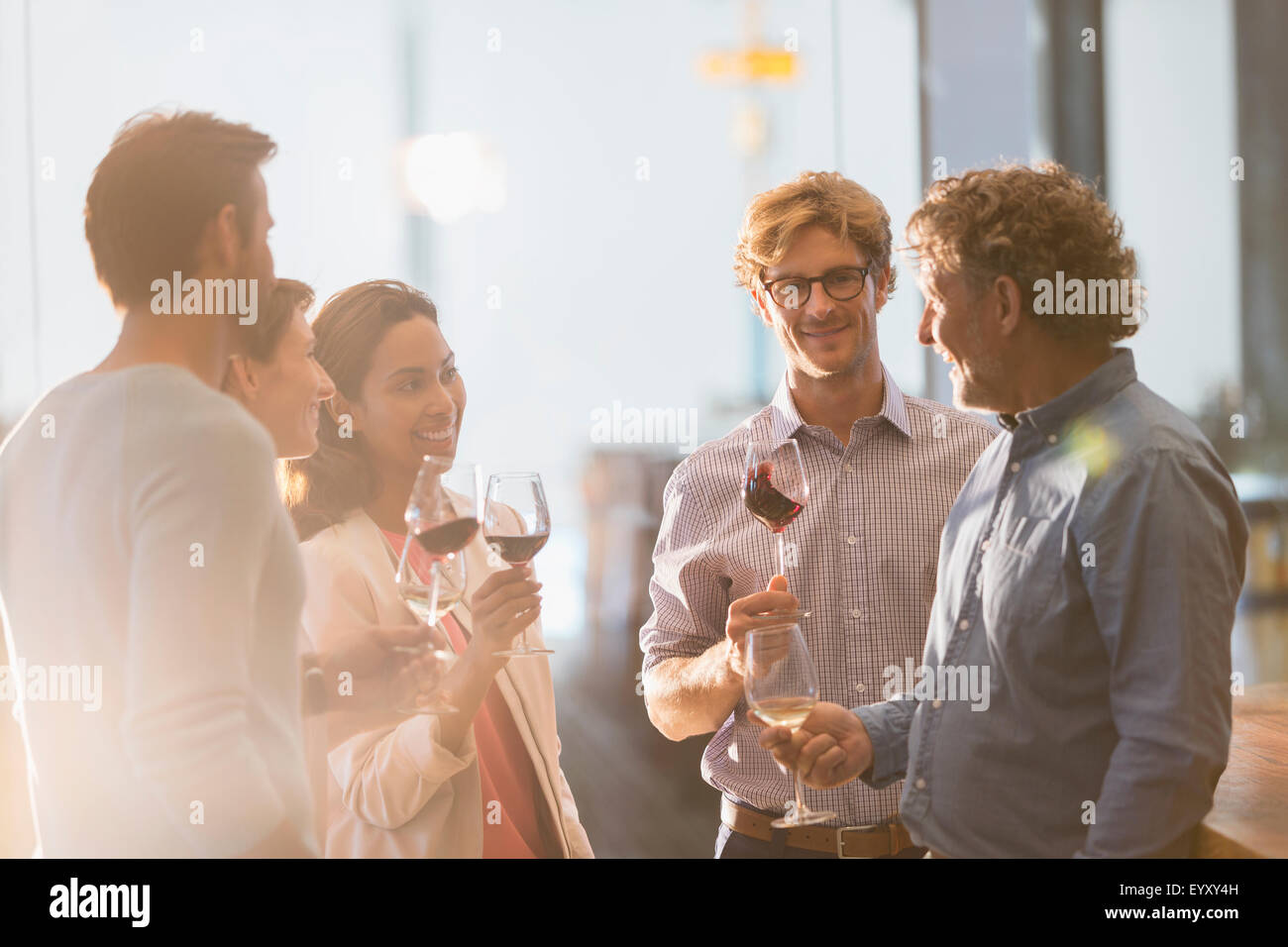 Friends wine tasting in winery tasting room Stock Photo - Alamy