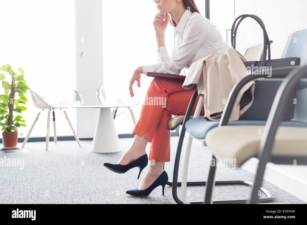 Crossed legs on chair hi-res stock photography and images - Alamy
