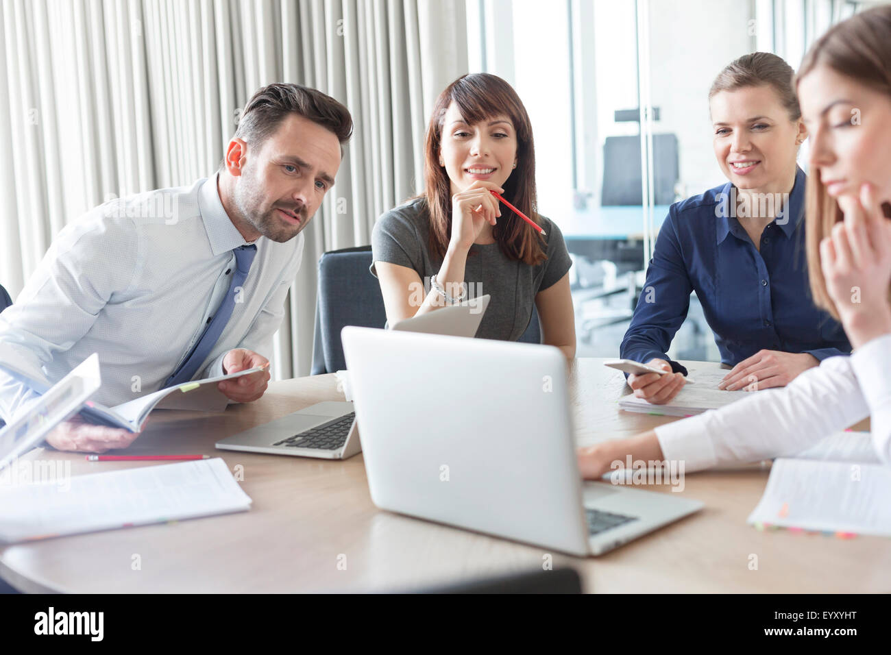 Business people working at laptop in conference room Stock Photo - Alamy