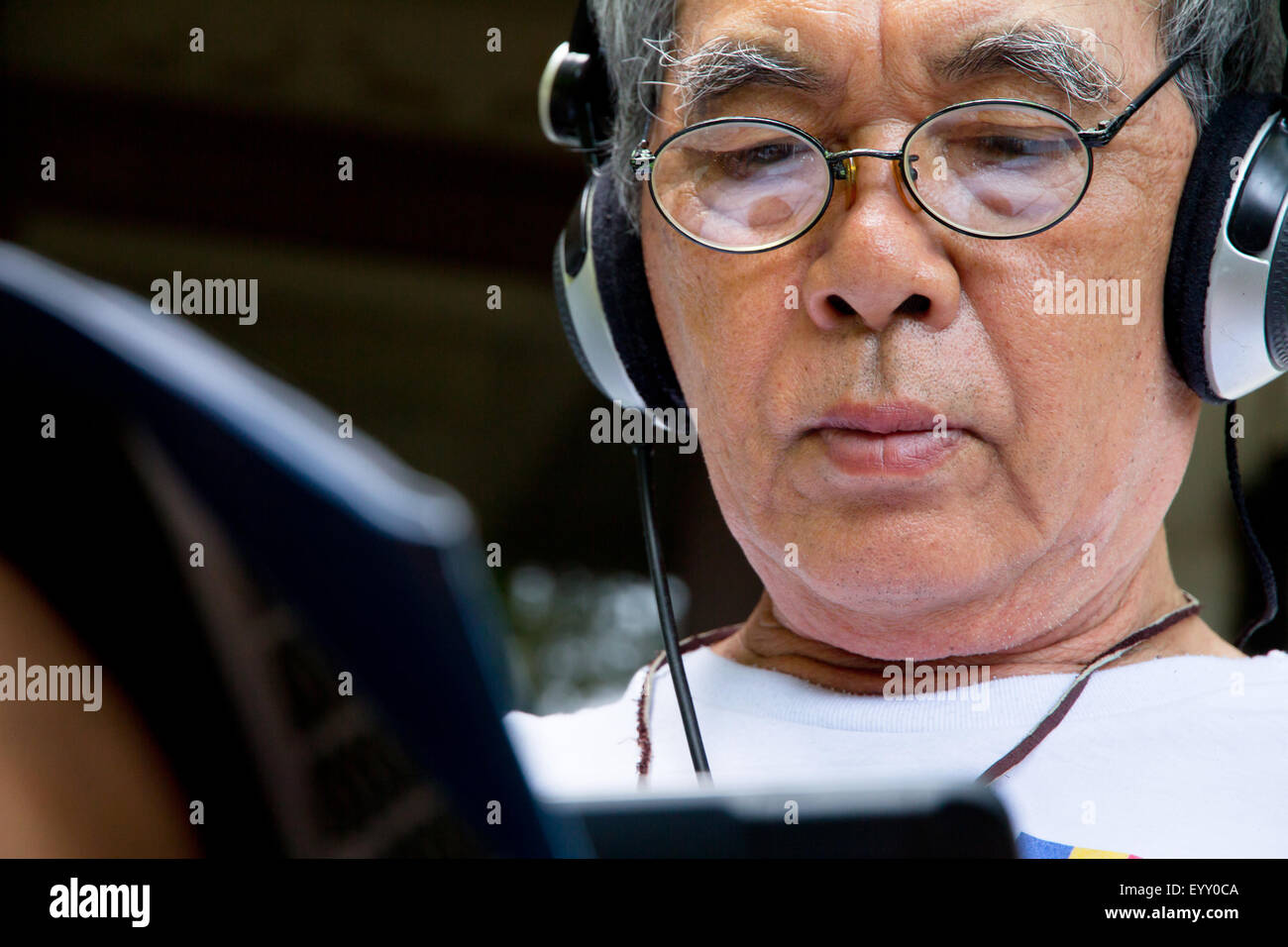 Senior man enjoying music on his tablet Stock Photo - Alamy