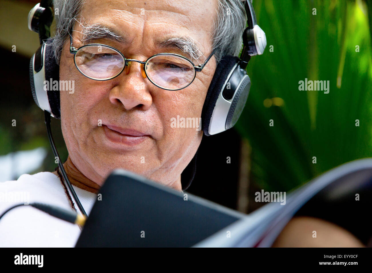 Senior man enjoying music on his tablet Stock Photo - Alamy