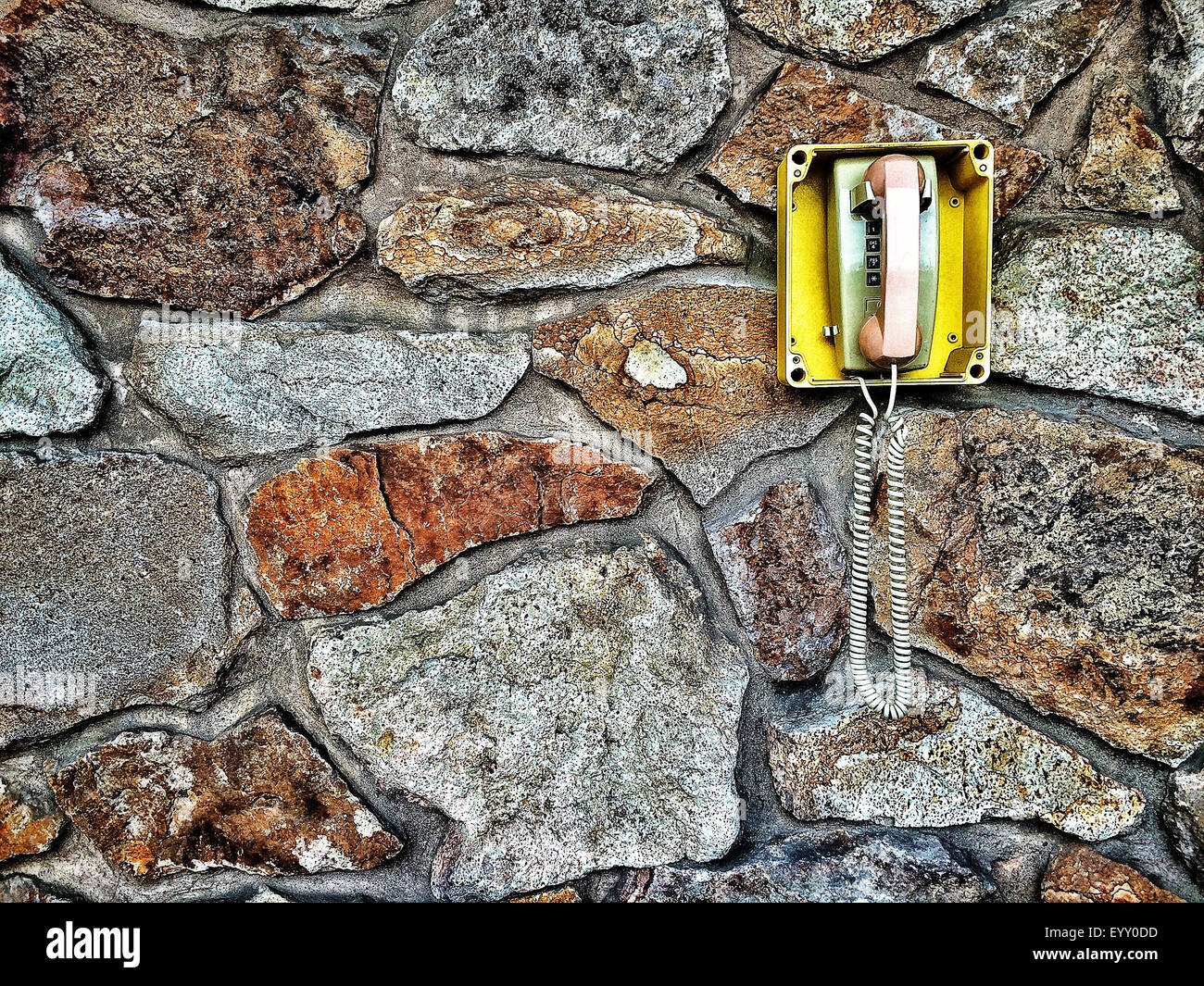 Close up of telephone in rock wall Stock Photo - Alamy