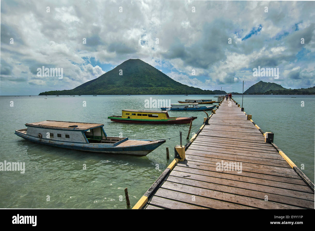 Jetty of Lonthor, the volcano Gunung Api behind, Banda Islands ...