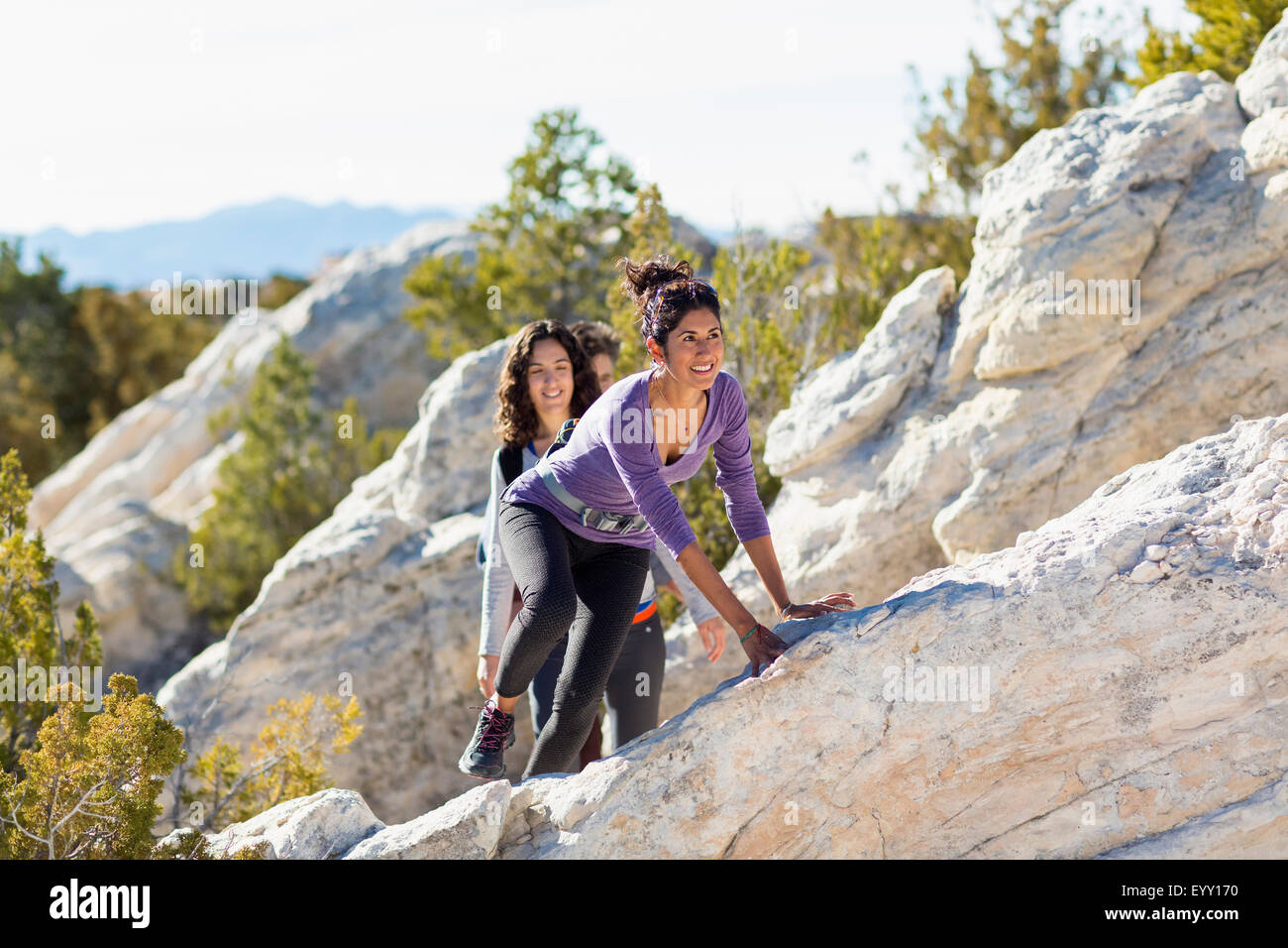 Hikers climbing rocky hillside Stock Photo - Alamy