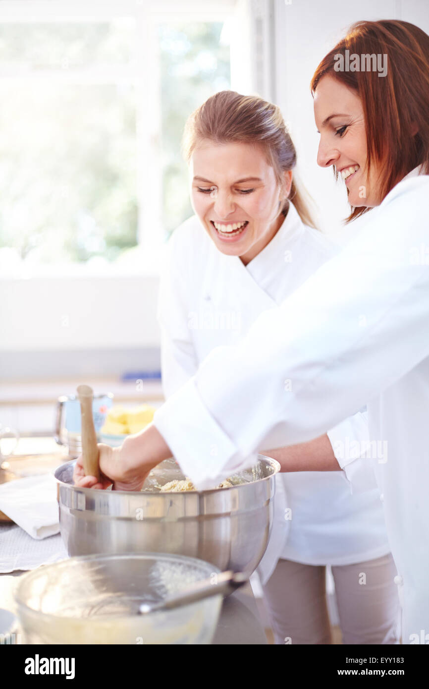 Smiling chefs baking in kitchen Stock Photo - Alamy