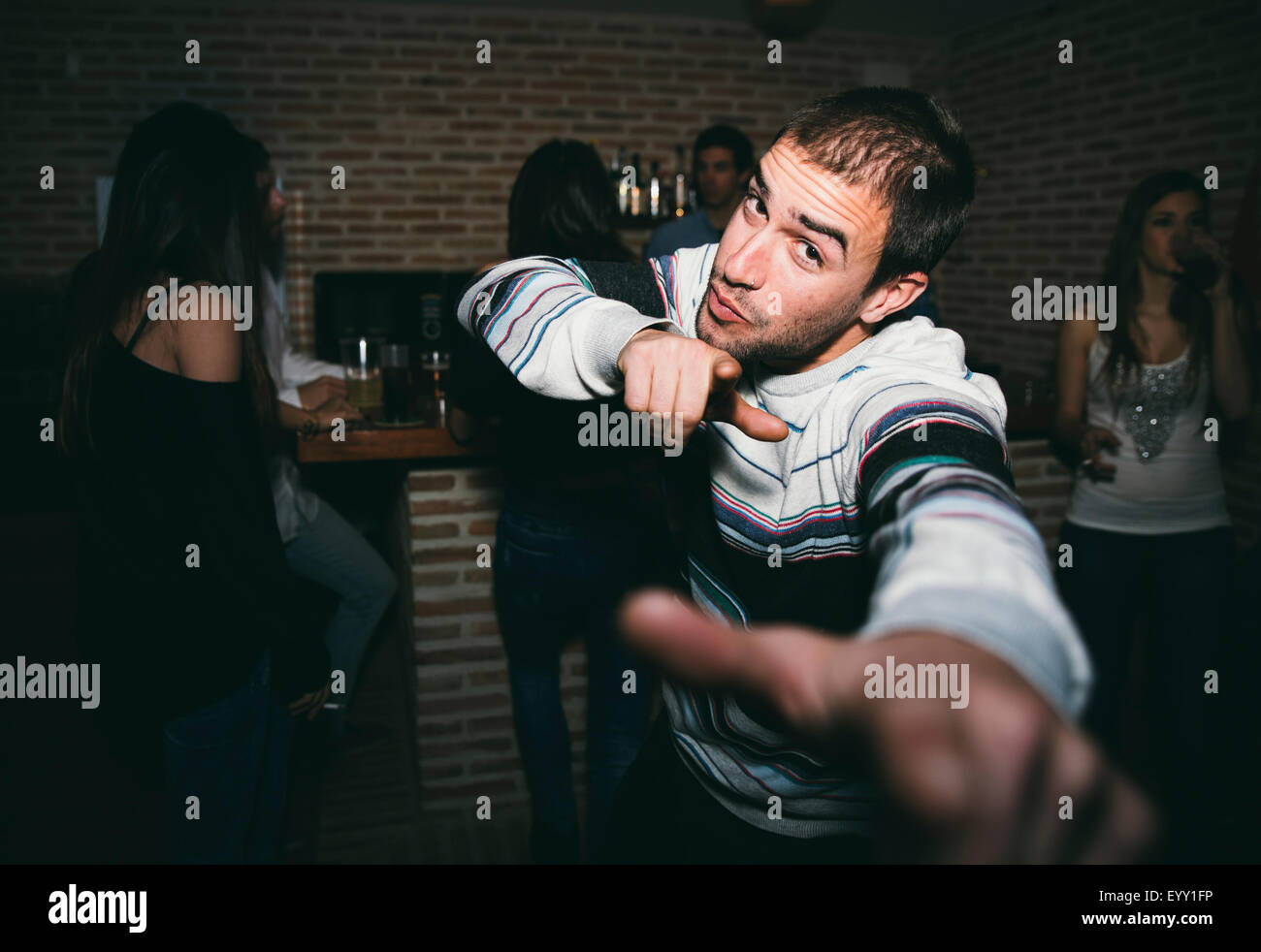 Hispanic woman in sweater pointing hi-res stock photography and images ...