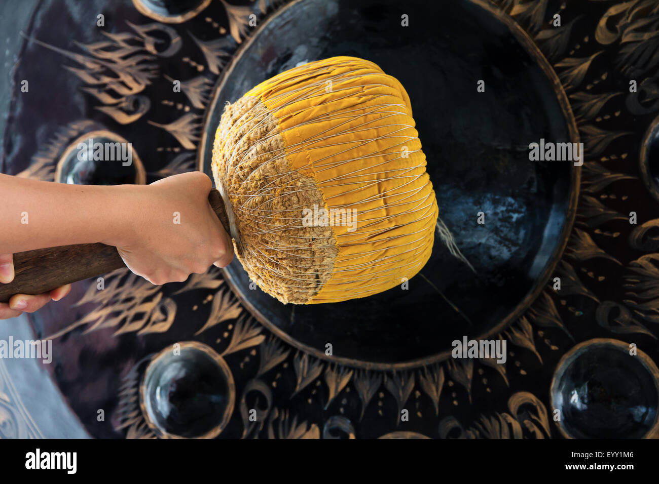 Hand hit big gong in temple Stock Photo - Alamy