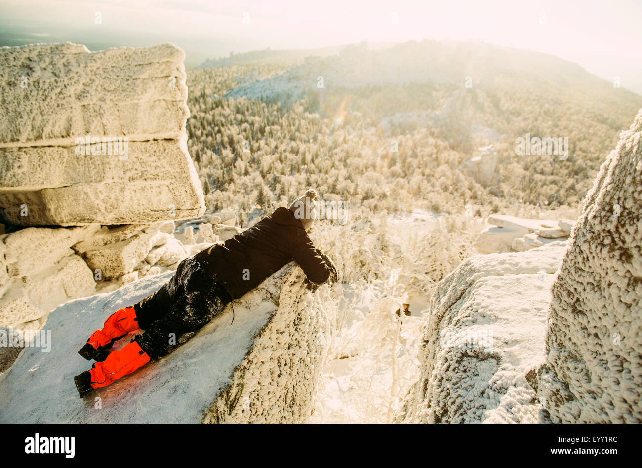Caucasian hiker laying on snowy rock formations Stock Photo - Alamy