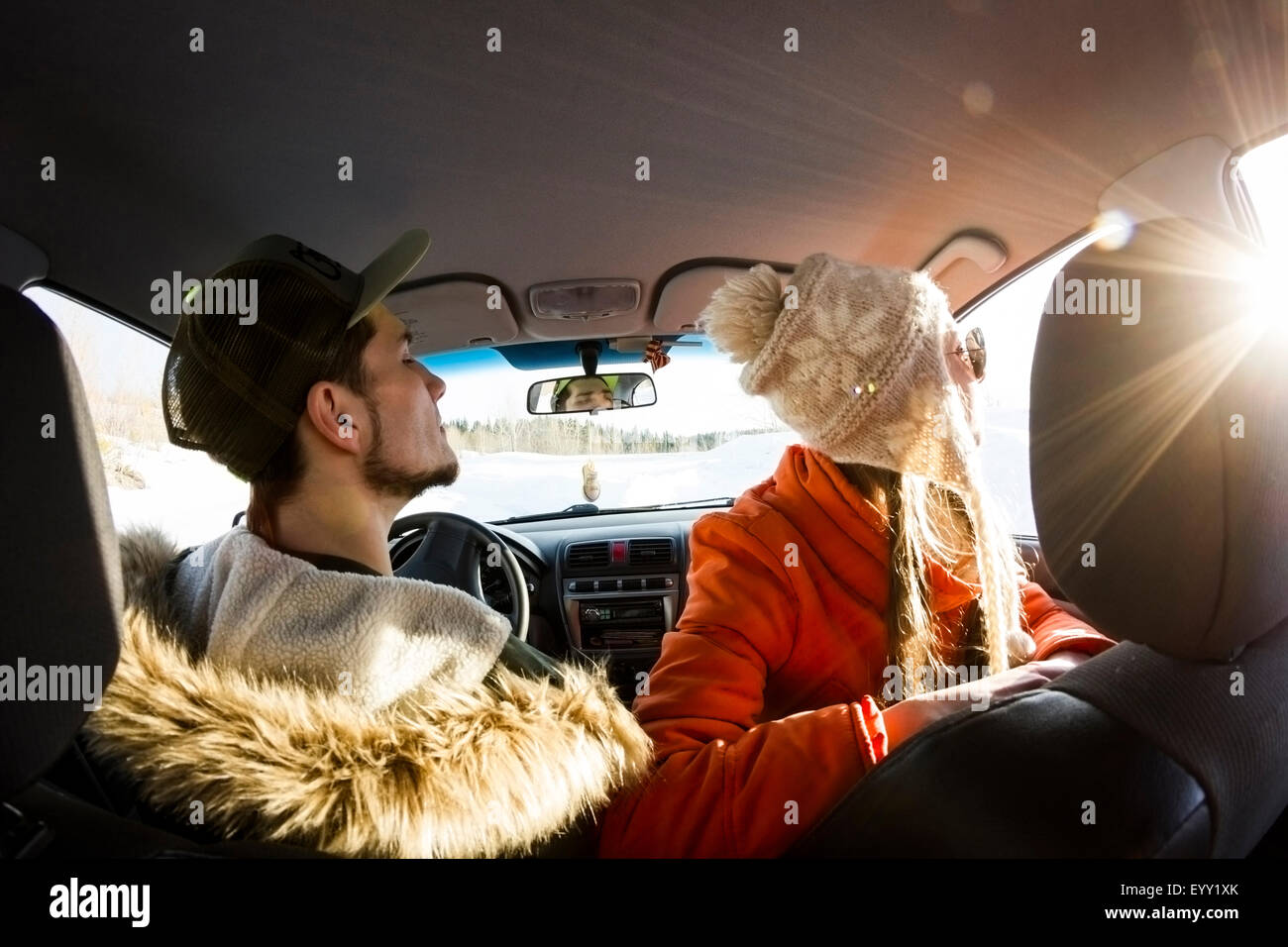 Caucasian couple looking out car window Stock Photo - Alamy