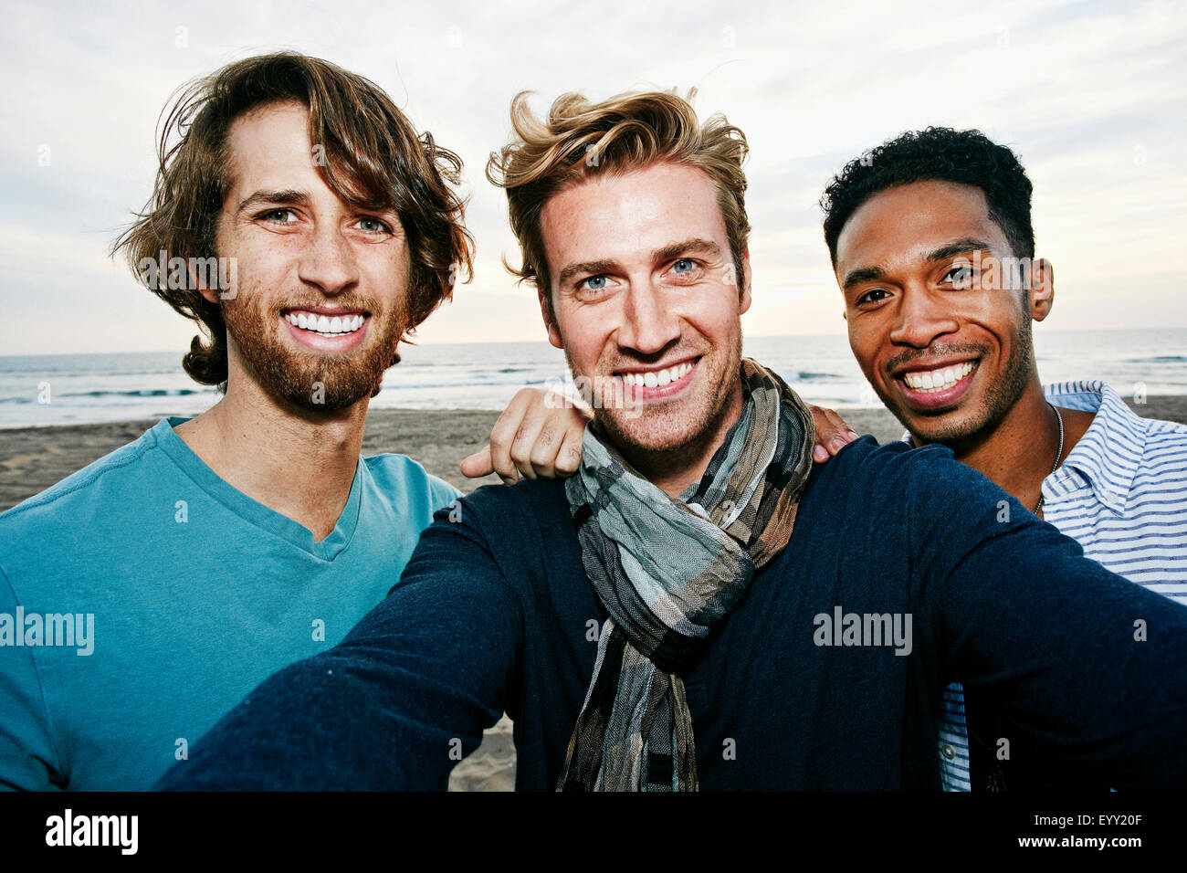Three men on a beach hi-res stock photography and images - Alamy