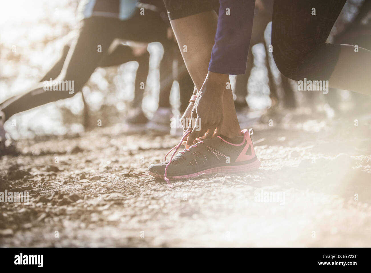 Close up of athlete tying shoe Stock Photo - Alamy