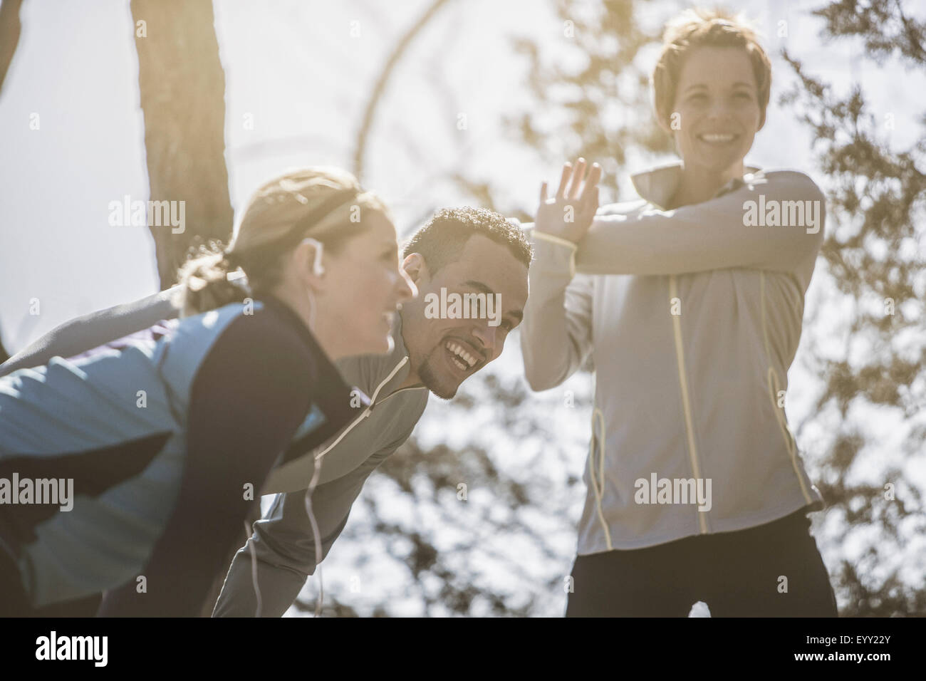 Close up of smiling athletes stretching Stock Photo - Alamy