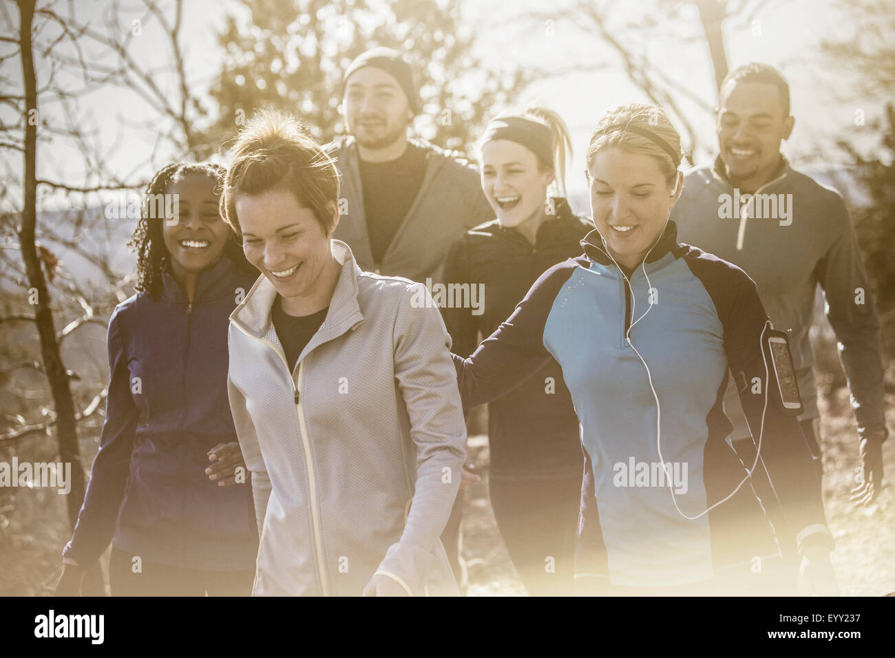Laughing friends walking on forest path Stock Photo - Alamy