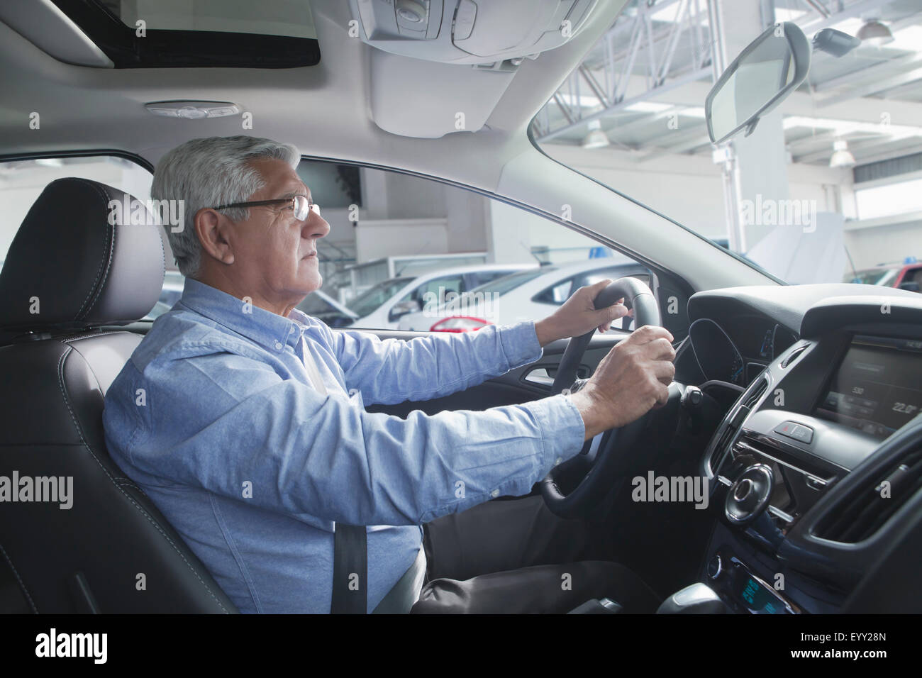 Hispanic customer test driving new car Stock Photo - Alamy