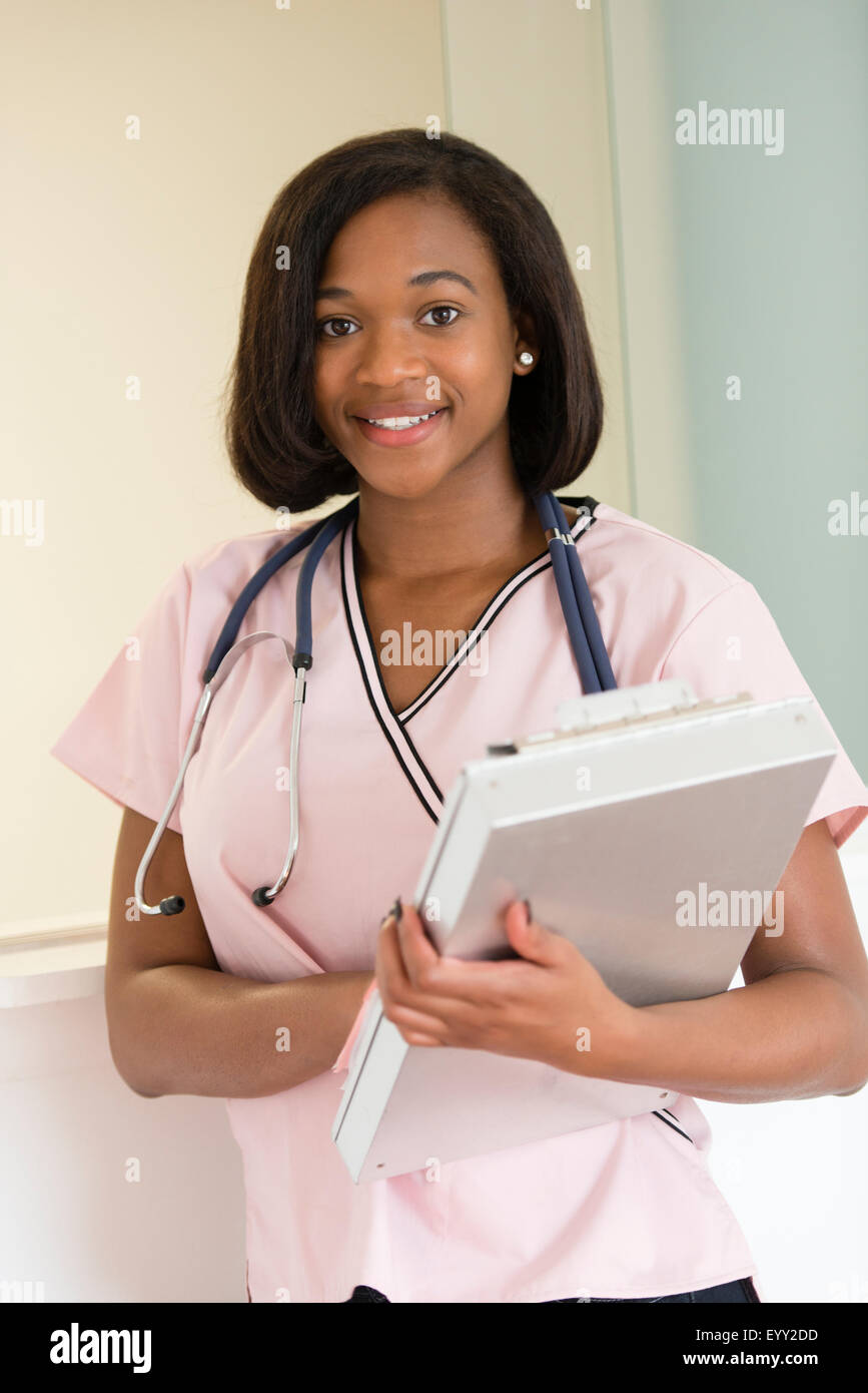 Mixed race nurse holding medical chart Stock Photo - Alamy