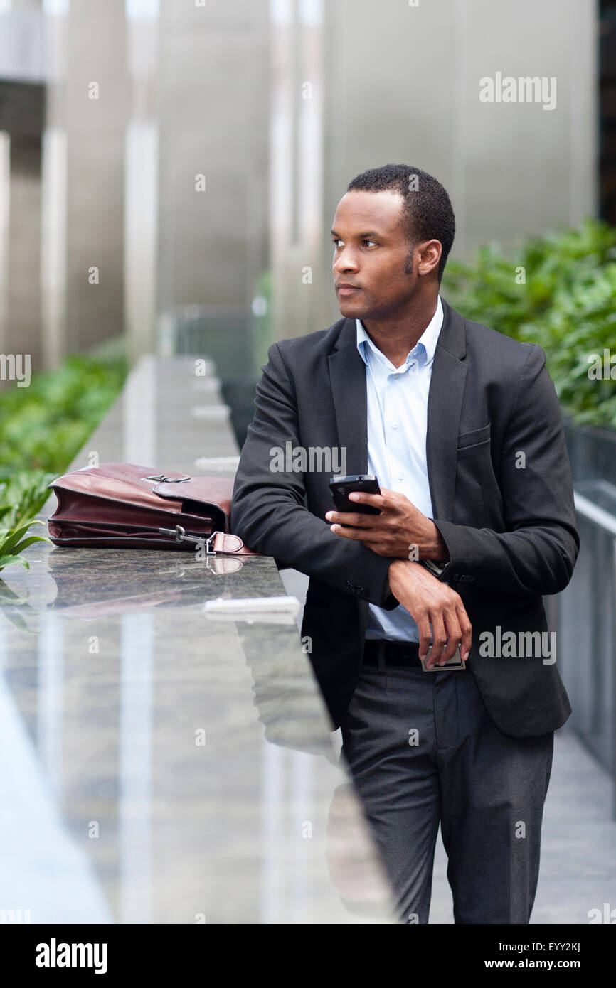 Businessman briefcase texting reading hi-res stock photography and ...
