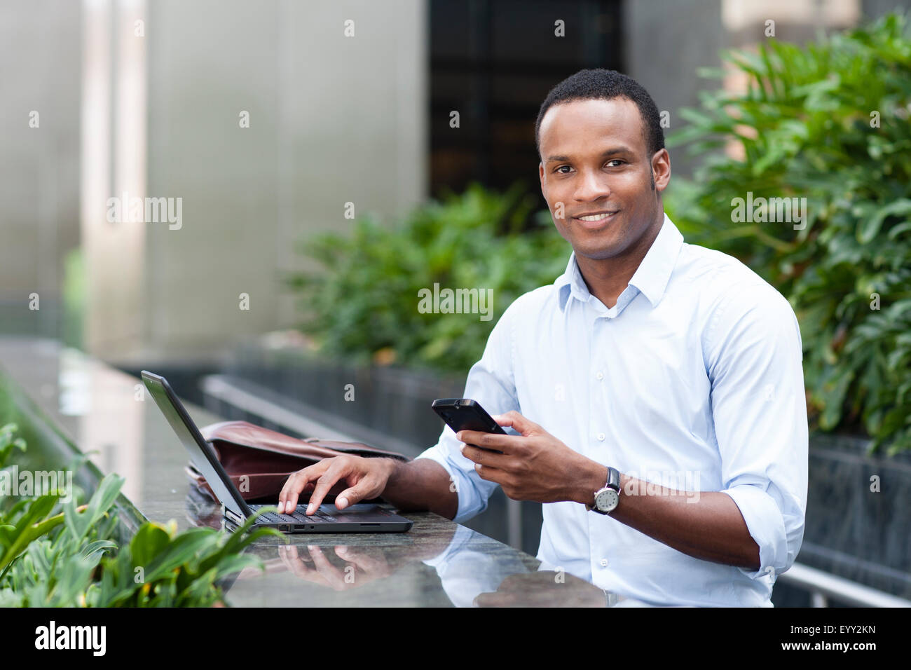 Businessman using laptop phone hi-res stock photography and images - Alamy