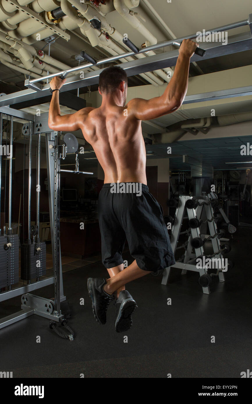 Caucasian athlete doing pull-ups in gymnasium Stock Photo - Alamy