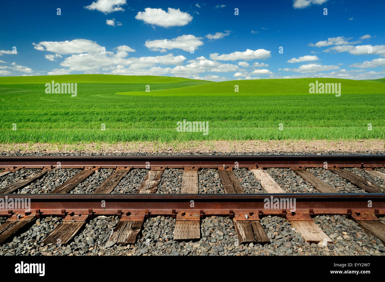 Railroad tracks and rolling hills in rural landscape Stock Photo - Alamy