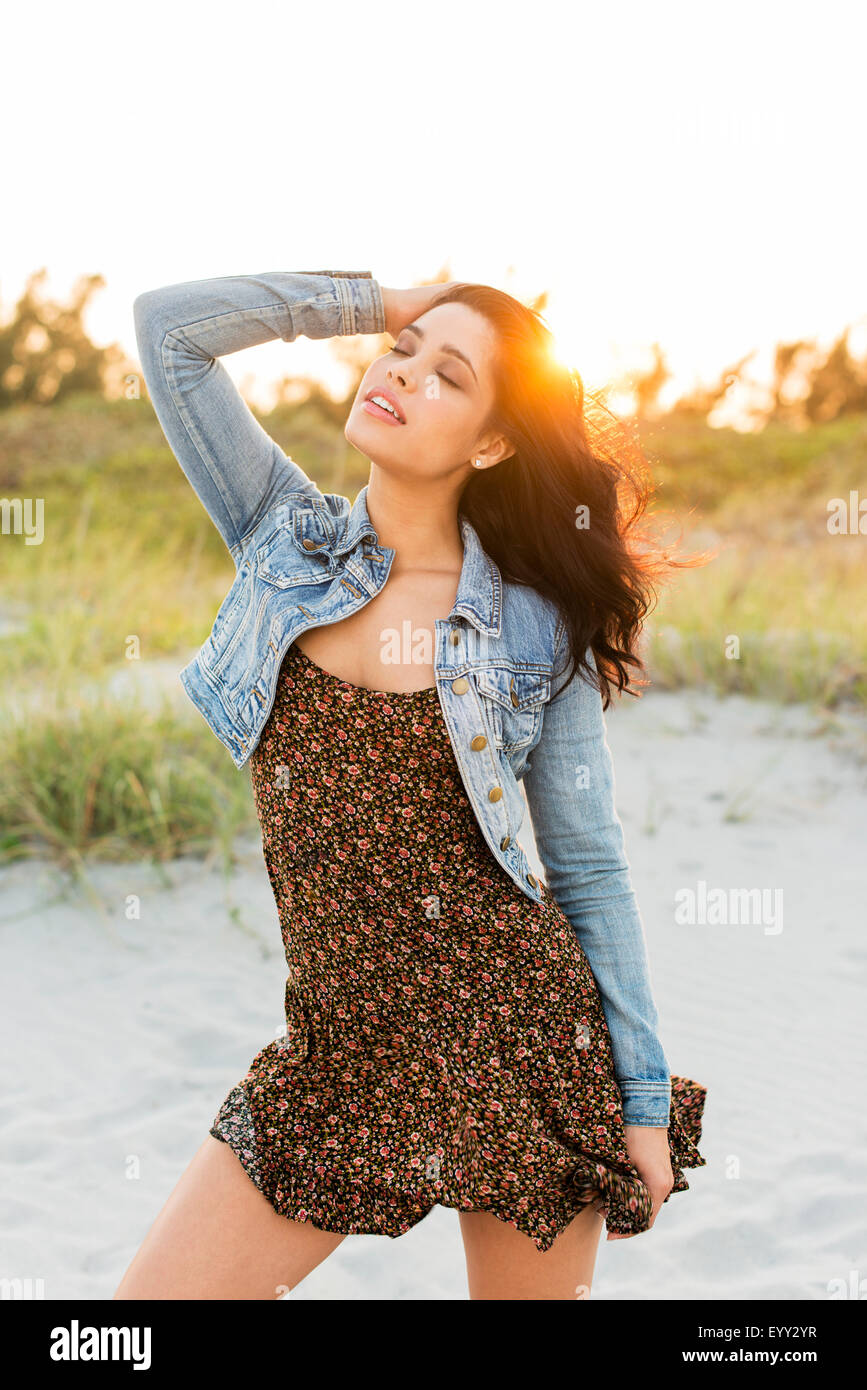 Hispanic woman standing on beach Stock Photo - Alamy
