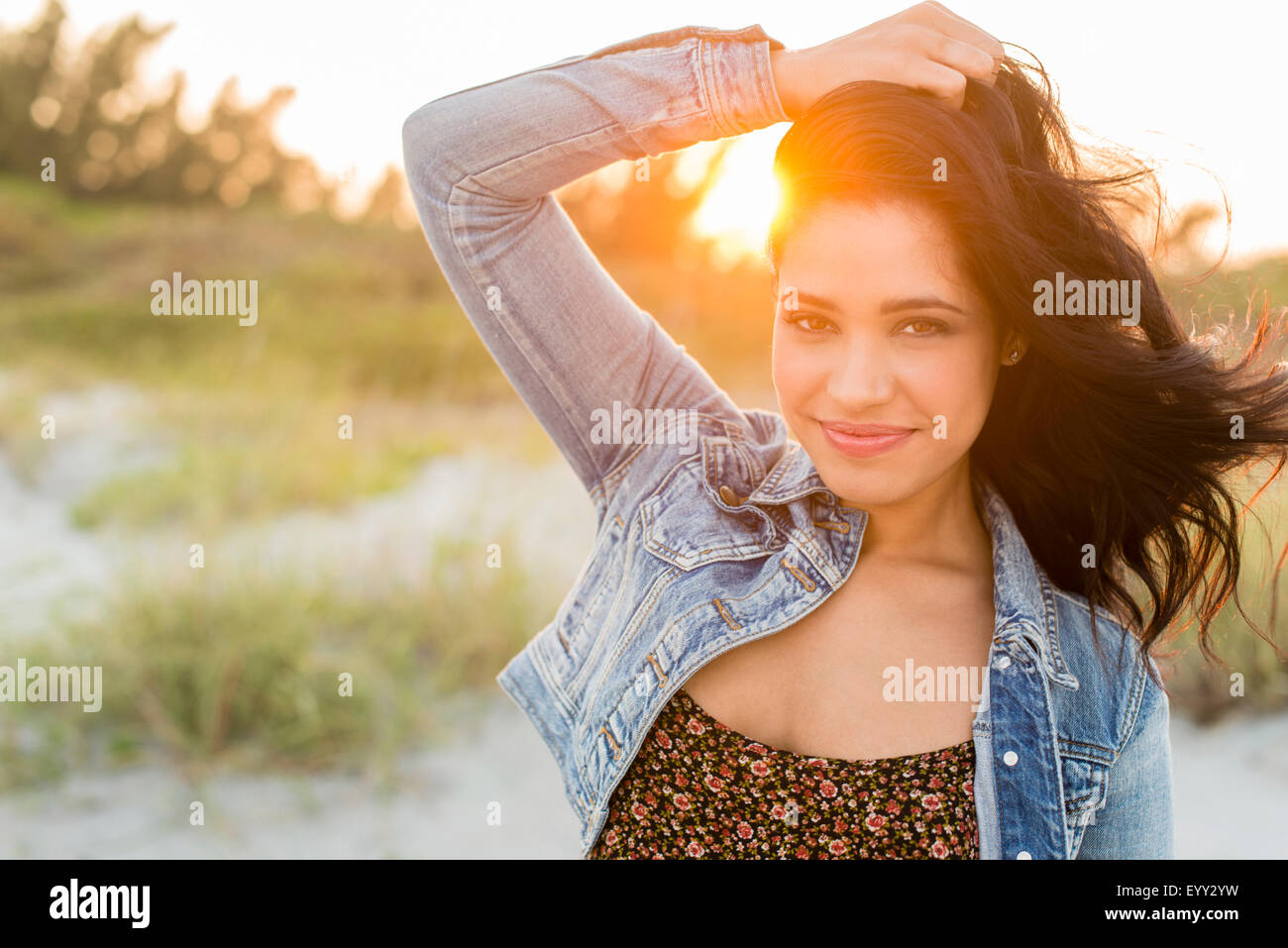 Hispanic woman standing on beach Stock Photo - Alamy