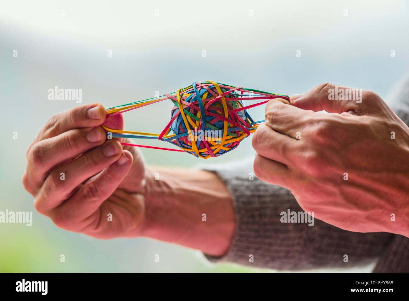 Pulling rubber band with hand hi-res stock photography and images - Alamy
