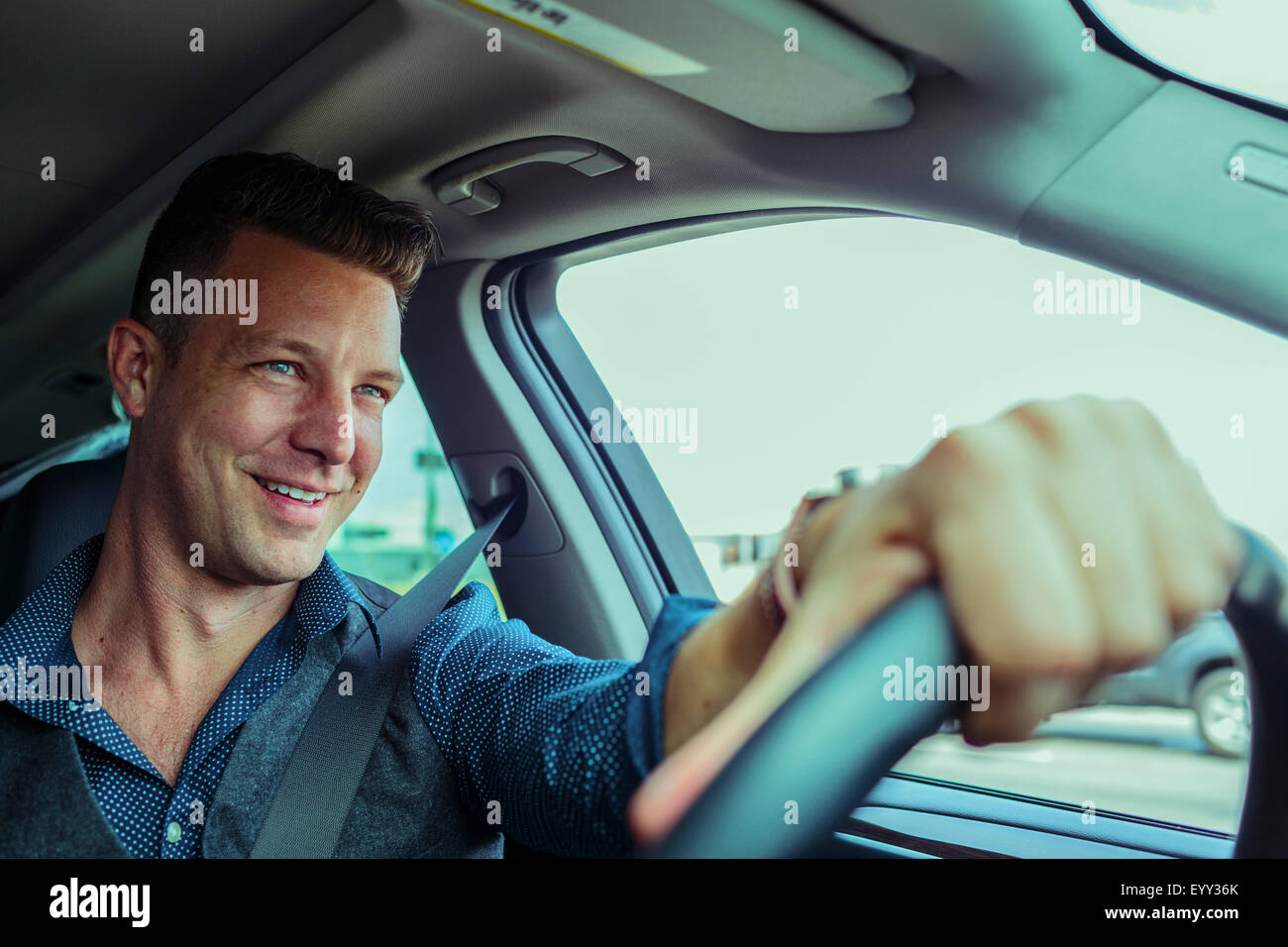 Smiling Caucasian man driving car Stock Photo - Alamy