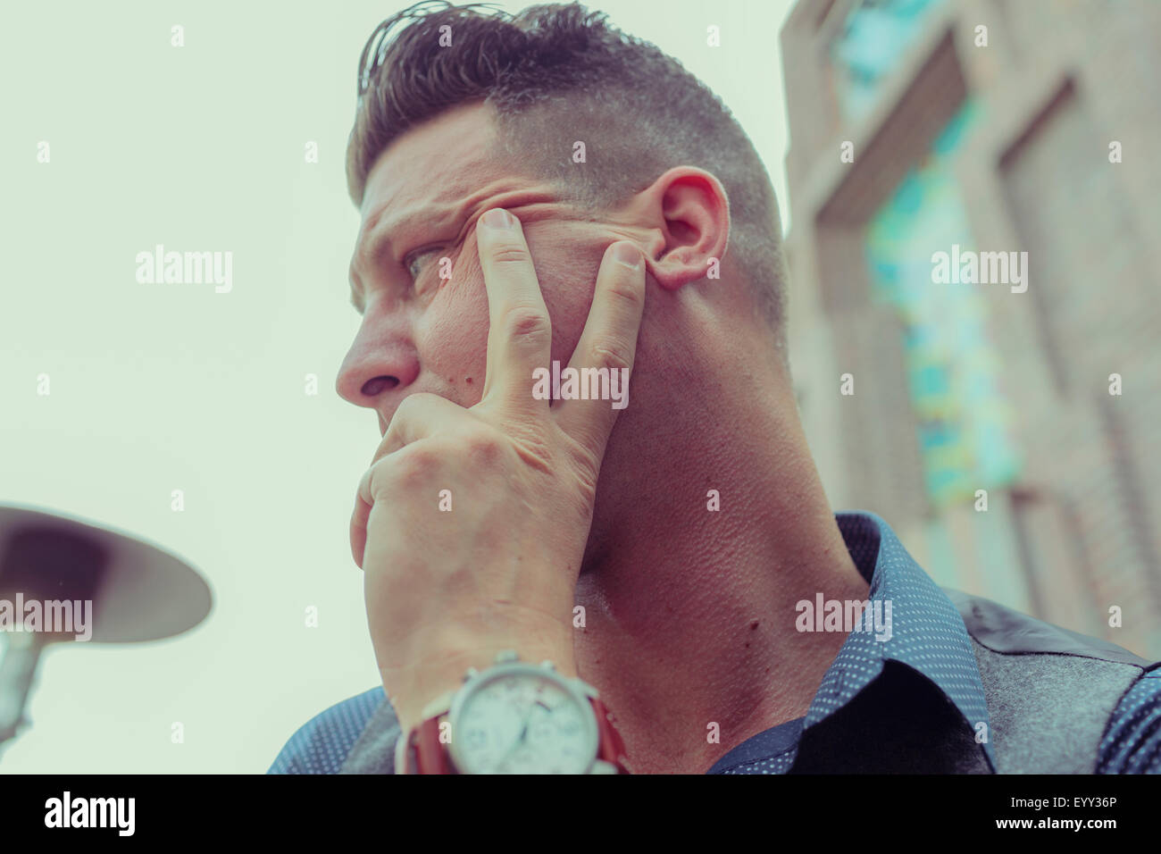 Caucasian businessman resting hand on chin Stock Photo - Alamy