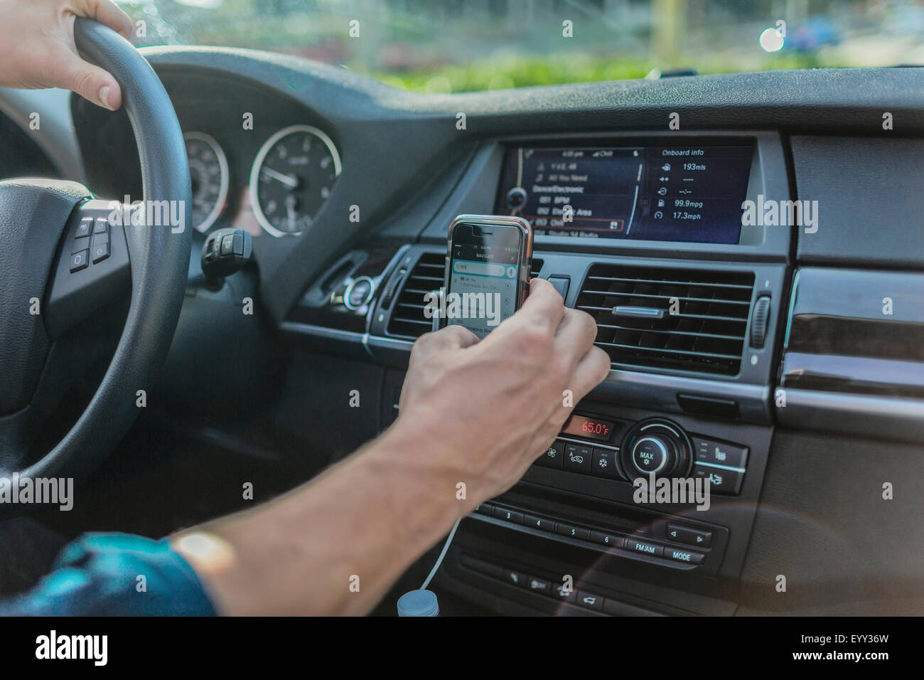 Caucasian man using cell phone and driving car Stock Photo - Alamy