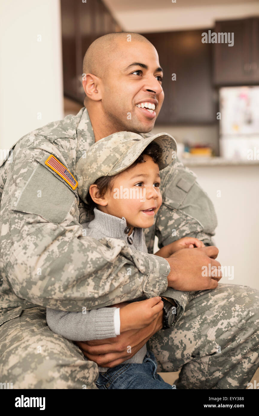 Mixed race soldier father hugging son Stock Photo - Alamy