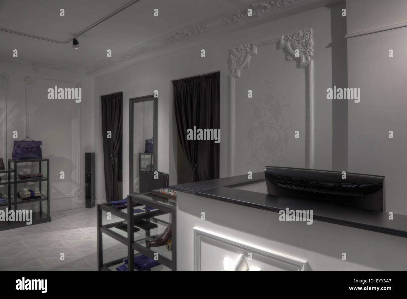 Dressing rooms and cash register behind empty store counter Stock Photo ...