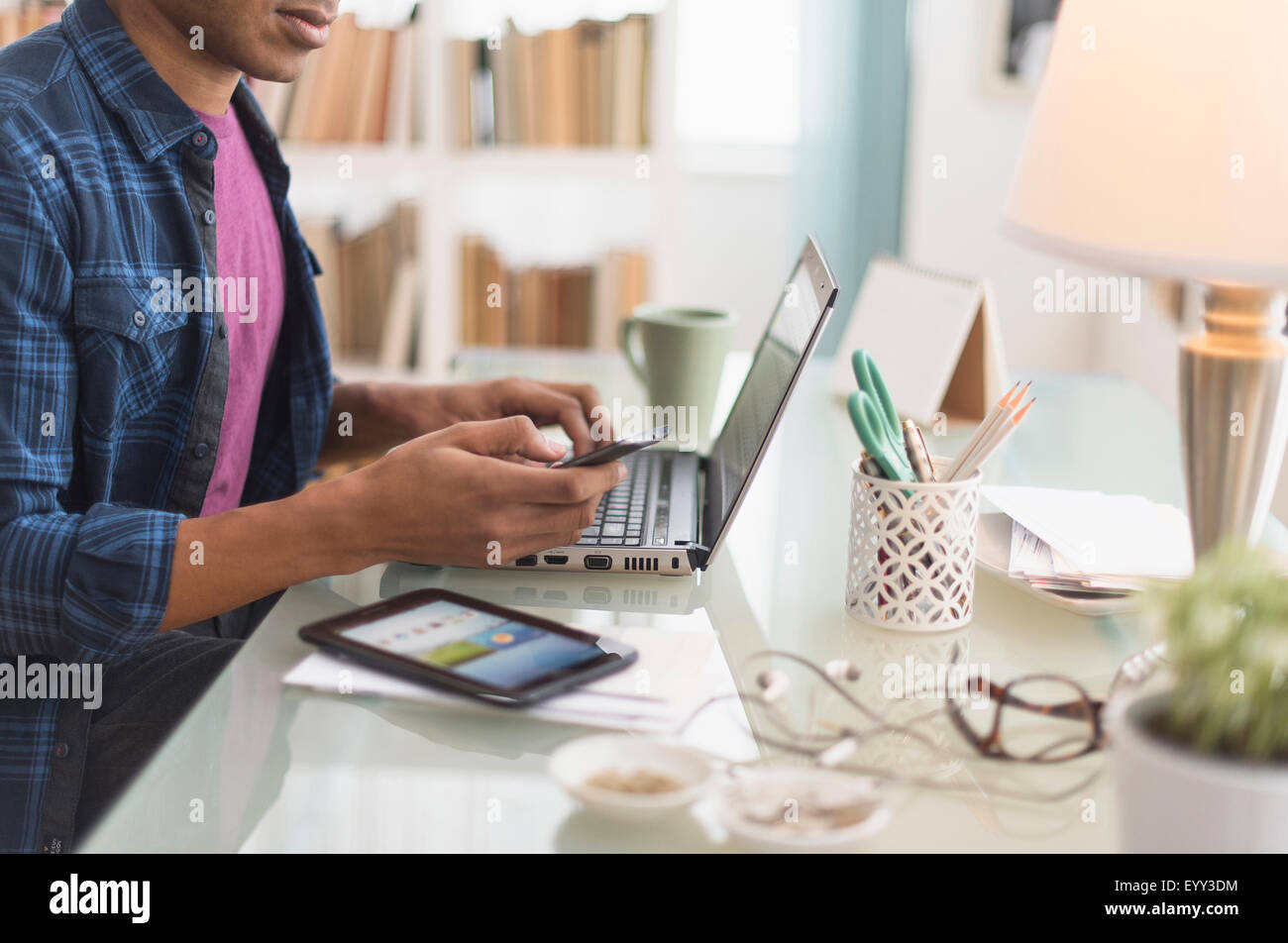 Black businessman multi-tasking at desk Stock Photo - Alamy Black businessman multi-tasking at desk Stock Photo - Alamy