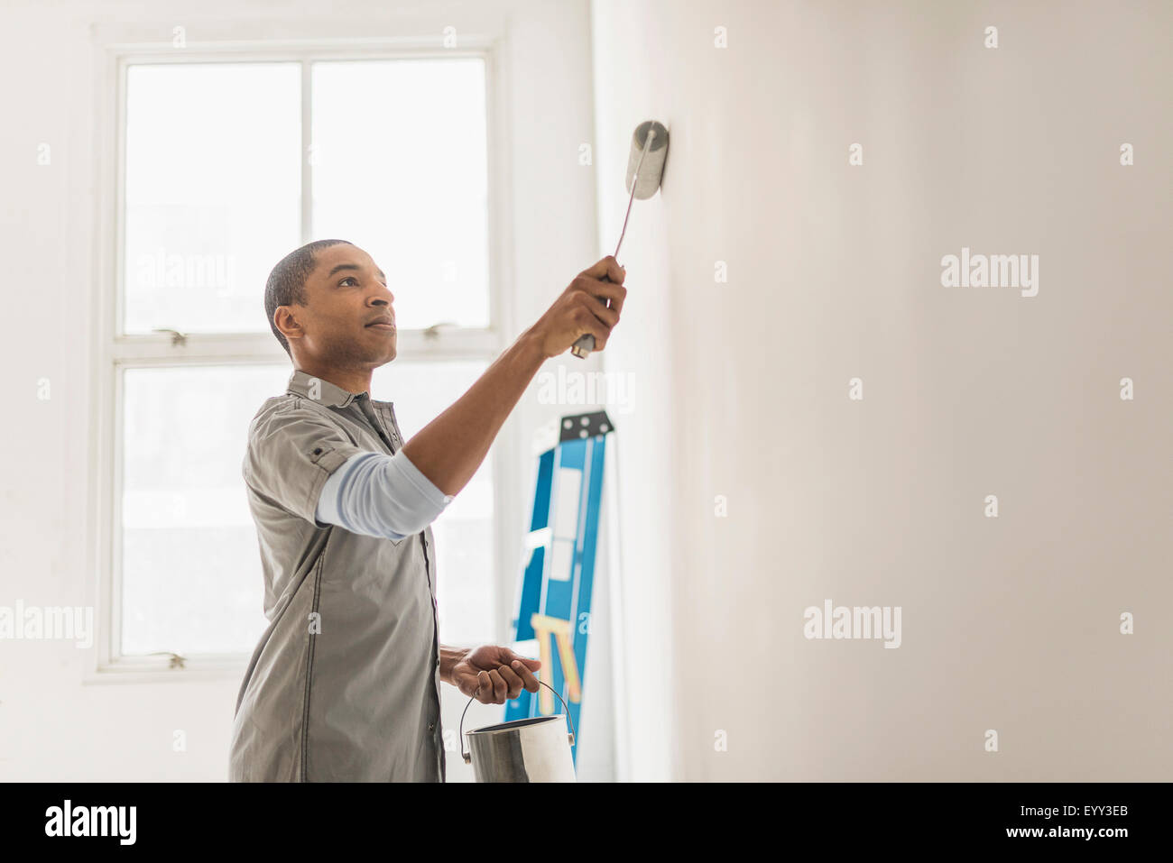 African american man painting wall hi-res stock photography and images ...