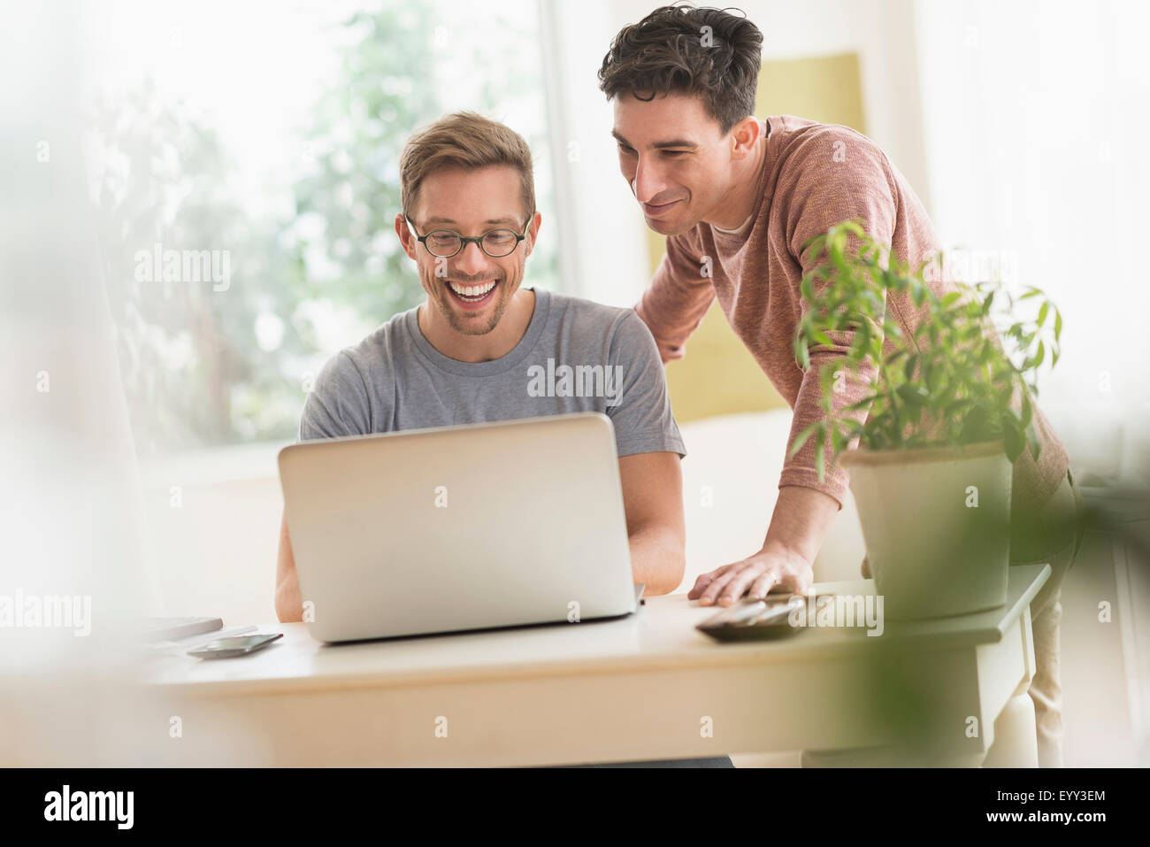 Caucasian gay couple using laptop Stock Photo - Alamy
