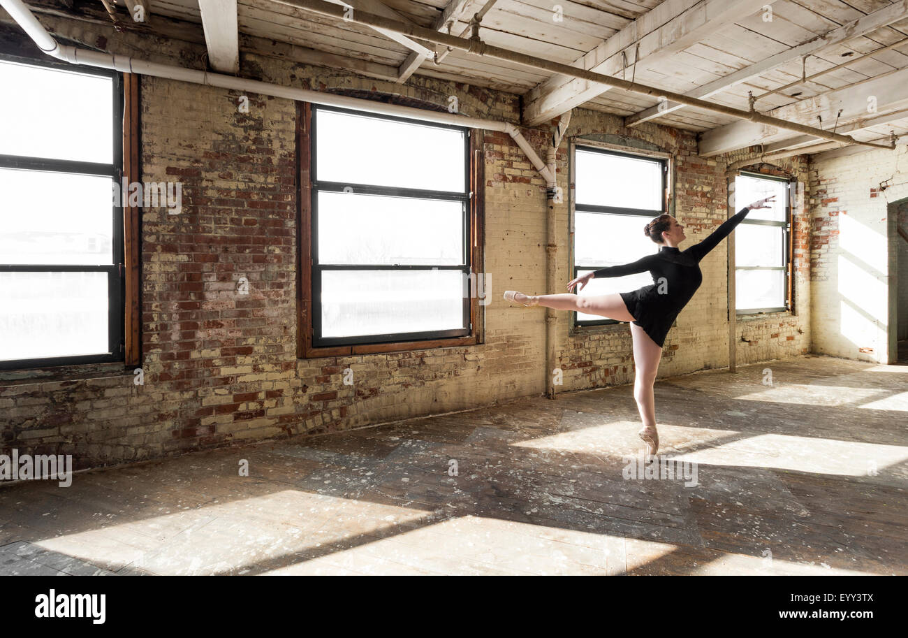 Caucasian ballet dancer performing in sunny loft room Stock Photo - Alamy