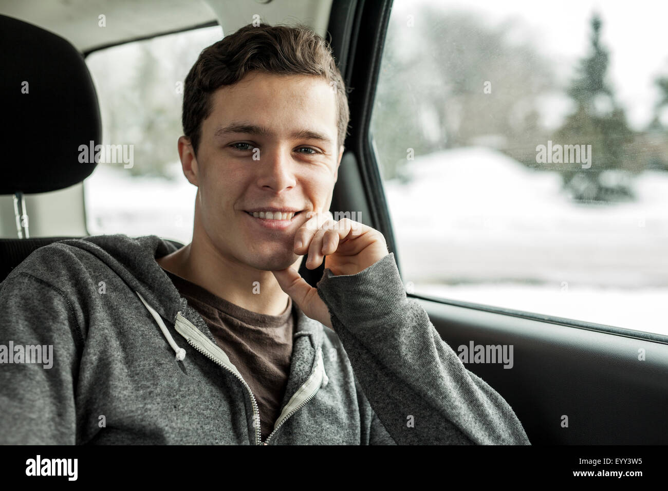 Caucasian man sitting in back seat of car Stock Photo - Alamy