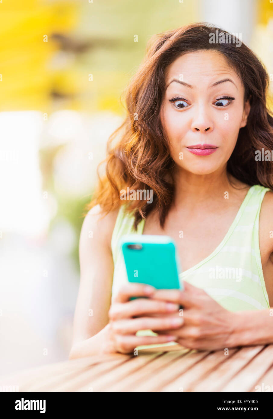 Chinese woman using cell phone at sidewalk cafe Stock Photo - Alamy