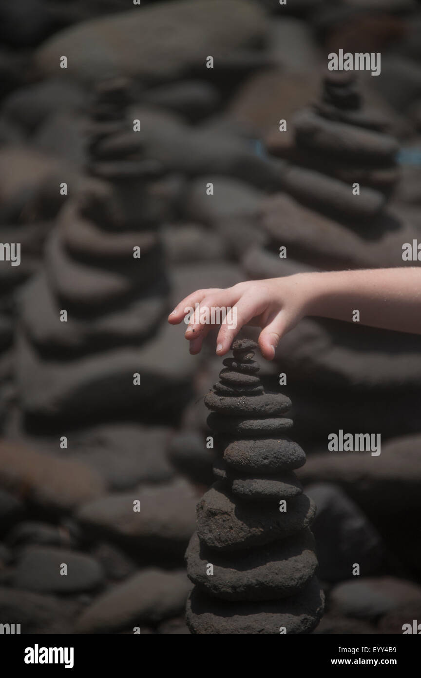 Close up of hand stacking rocks Stock Photo - Alamy