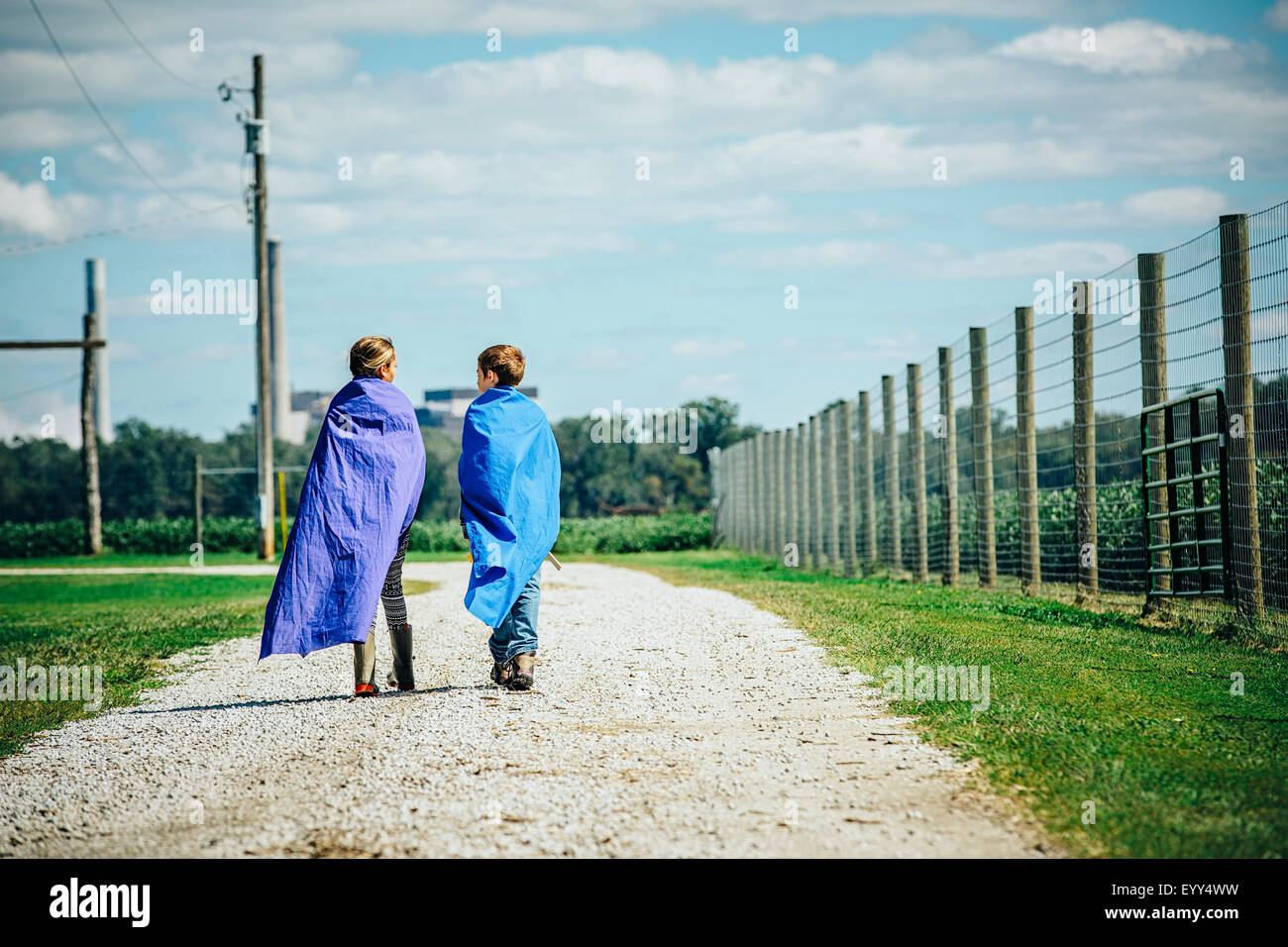 Caucasian children wearing capes on dirt road Stock Photo - Alamy