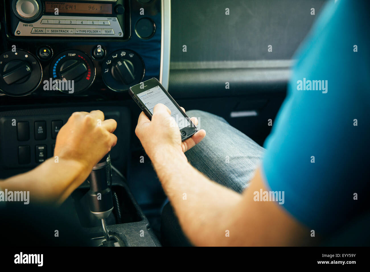 Caucasian man using cell phone in car Stock Photo - Alamy