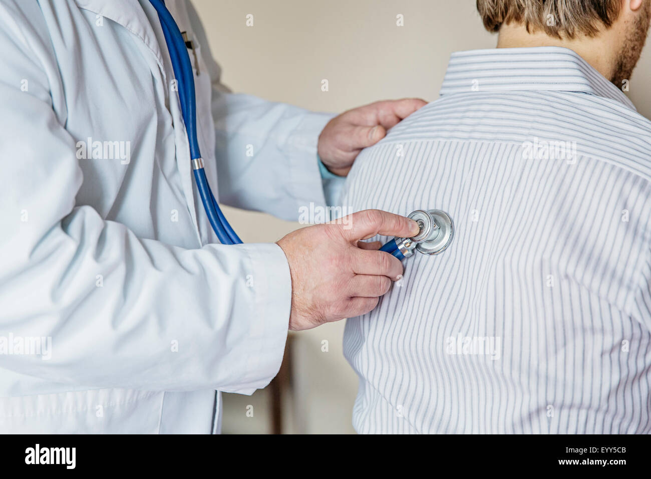 Caucasian doctor listening to heartbeat of patient Stock Photo - Alamy