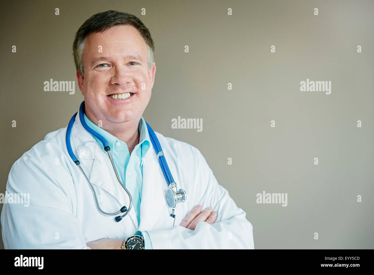 Caucasian doctor standing with arms crossed Stock Photo - Alamy