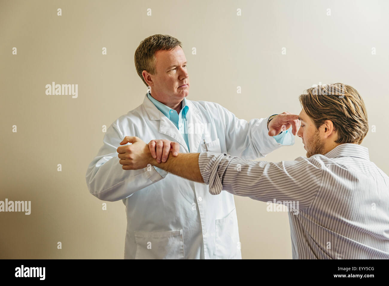 Doctor stretching man arm hi-res stock photography and images - Alamy