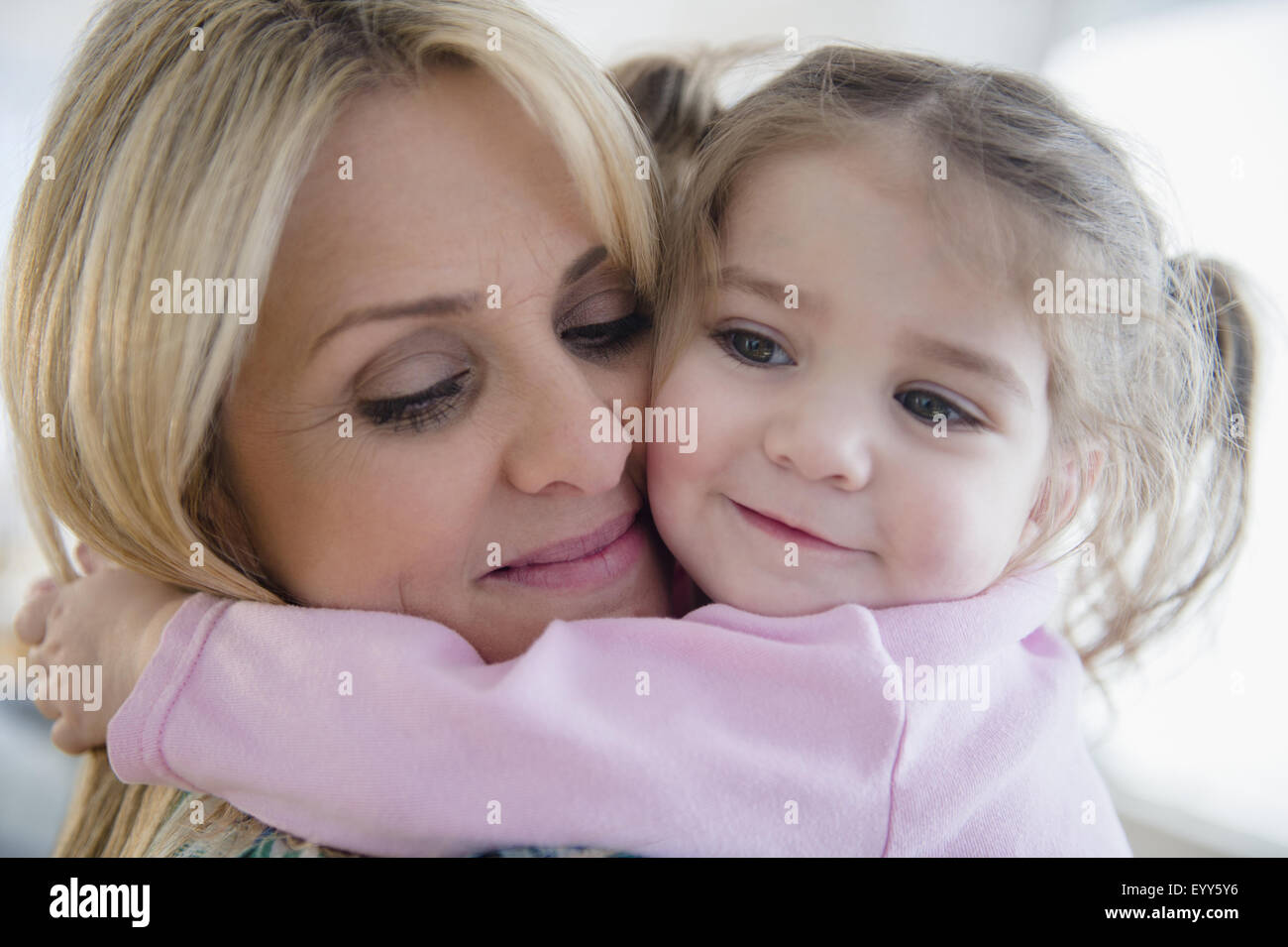 Hugging Mother Hugging Daughter Indoors High Resolution Stock ...