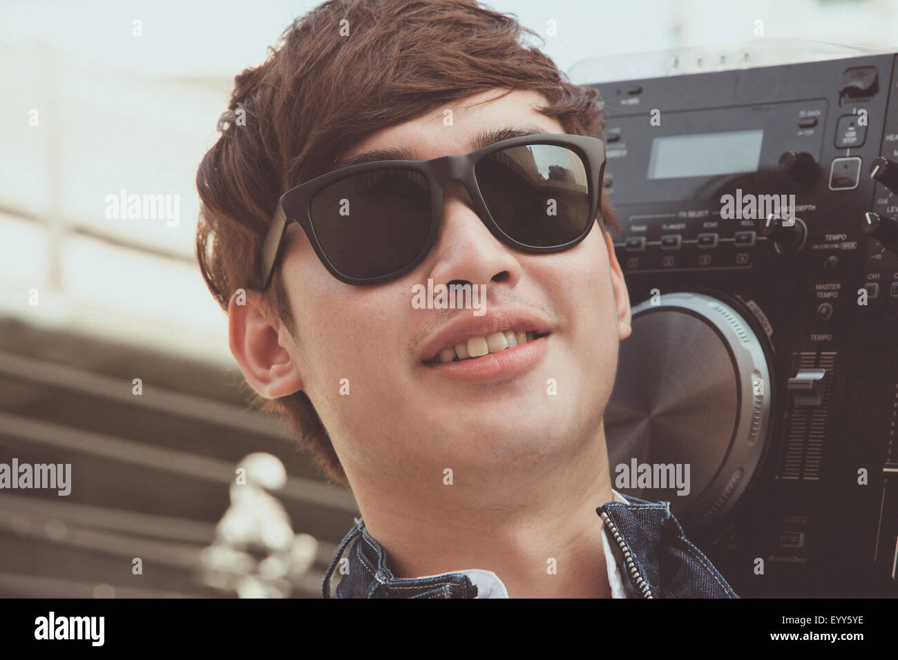Handsome asian guy with turntables dj mixer Stock Photo - Alamy