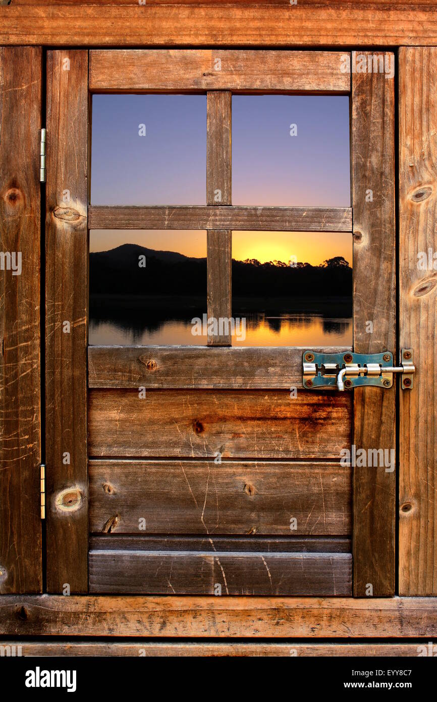 Timber Door with window to sunset and river Stock Photo - Alamy